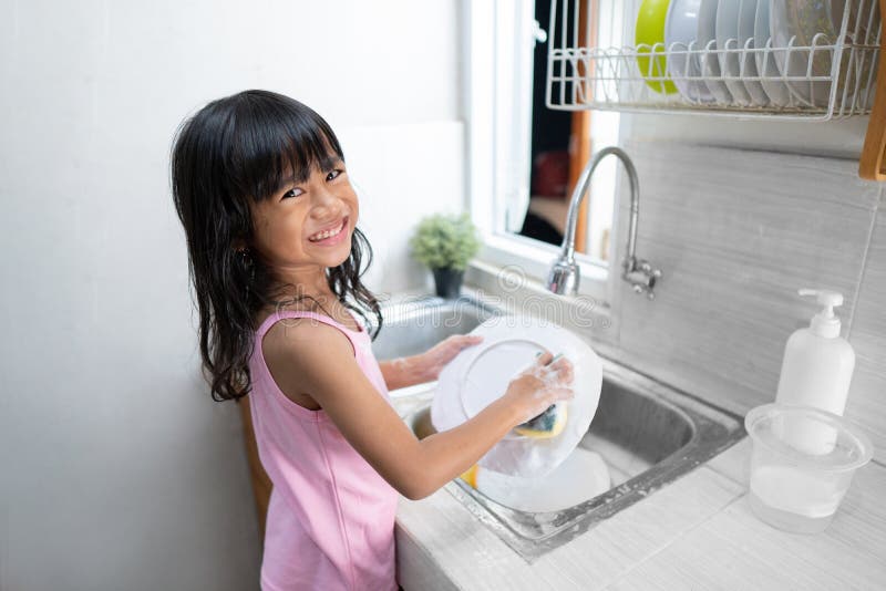 Kid Washing the Dishes and Looking Stock Photo - Image of dishes ...