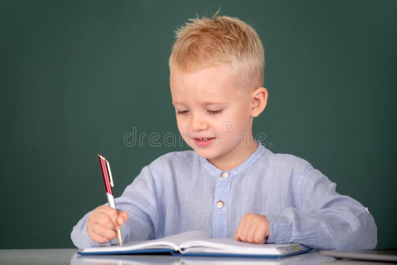 Kid Writing in Class. School Boy Studying Math on Lesson in Classroom ...