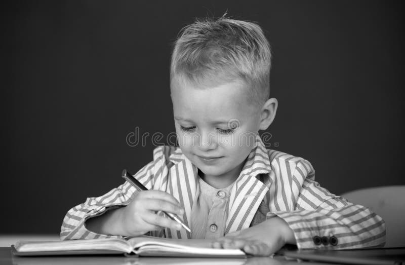 Kid Writing in Class. School Boy Studying Math on Lesson in Classroom ...