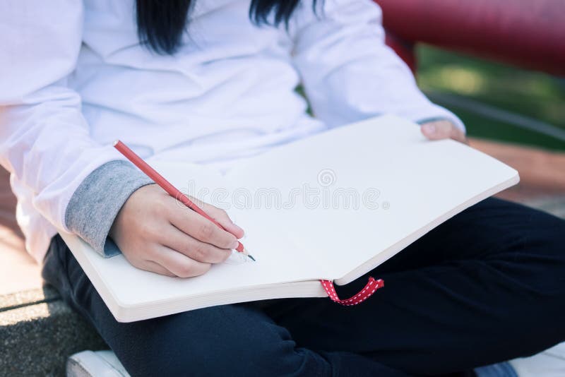 Kid writing on note paper. stock photo. Image of pencil - 98039858