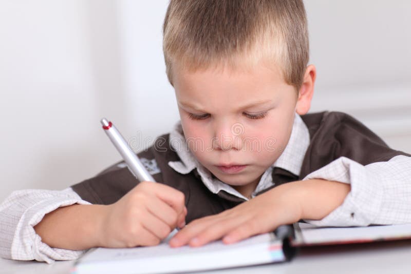 Blond Boy Child Kid with Pen Writing on Piece of Paper. at Home. Stock ...
