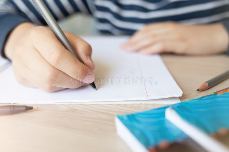 Kid writing in notebook. stock image. Image of secondary - 119409291