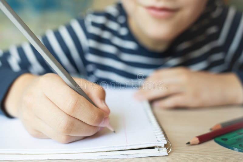 Kid writing in notebook. stock image. Image of notebook - 118363291