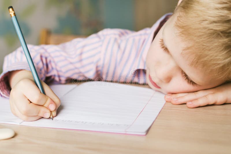 Kid writing in notebook stock image. Image of table - 116871917