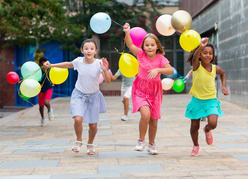 Kids with Balloons Running through Streets Stock Photo - Image of town ... Kids with Balloons Running through Streets Stock Photo - Image of town ...