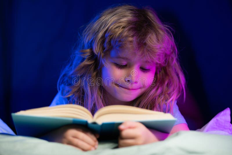Kids Bedtime. Close Up Portrait of Boy Reading a Book in Bed. Stock ...