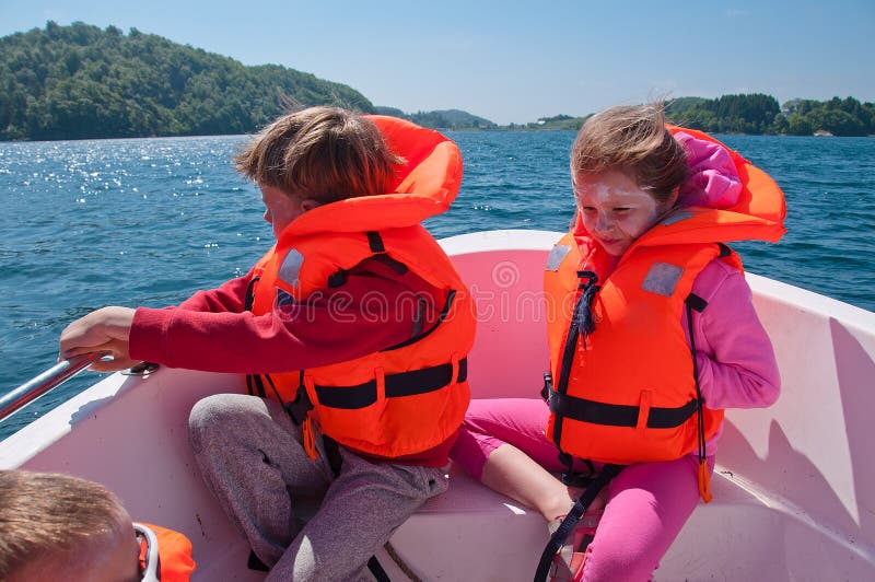 Kids floating in a boat stock image. Image of smiling - 55467875