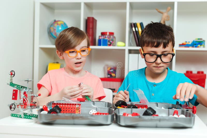 Kids Building Robots at Robotics School Lesson. Students Creating Metal ...