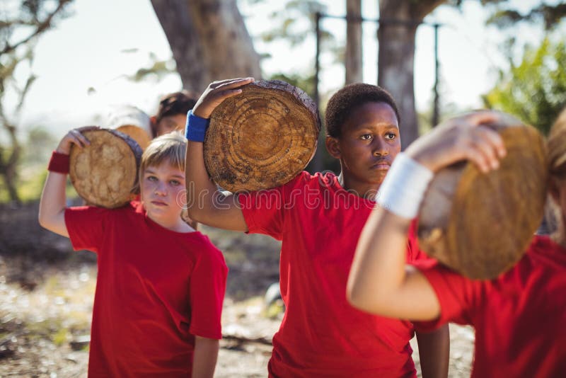 Kids Carrying Wooden Log during Obstacle Course Training Stock Photo ...