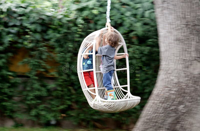 Kids on a chair swing. editorial image. Image of swinging - 88631185