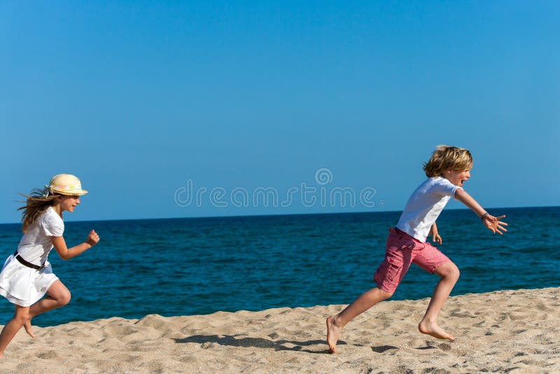 Kids chasing each other. stock image. Image of beach - 31229373
