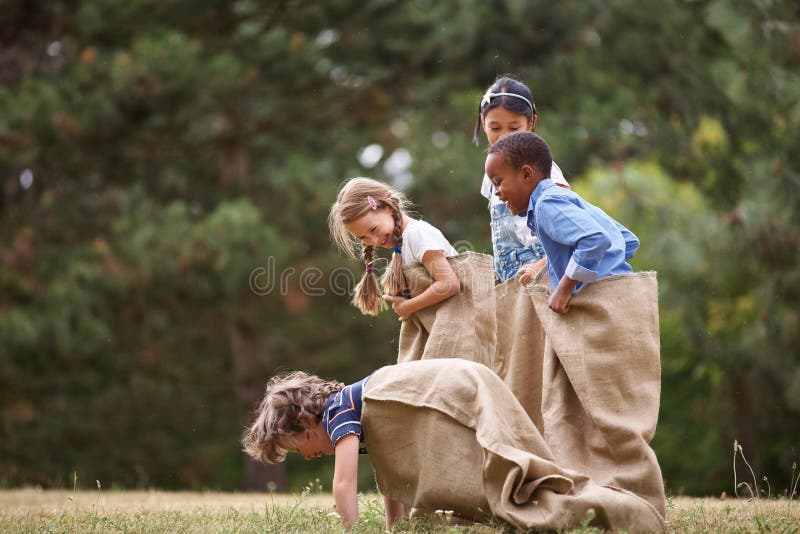 Kids at a sack race stock photo. Image of community, interracial - 87806592