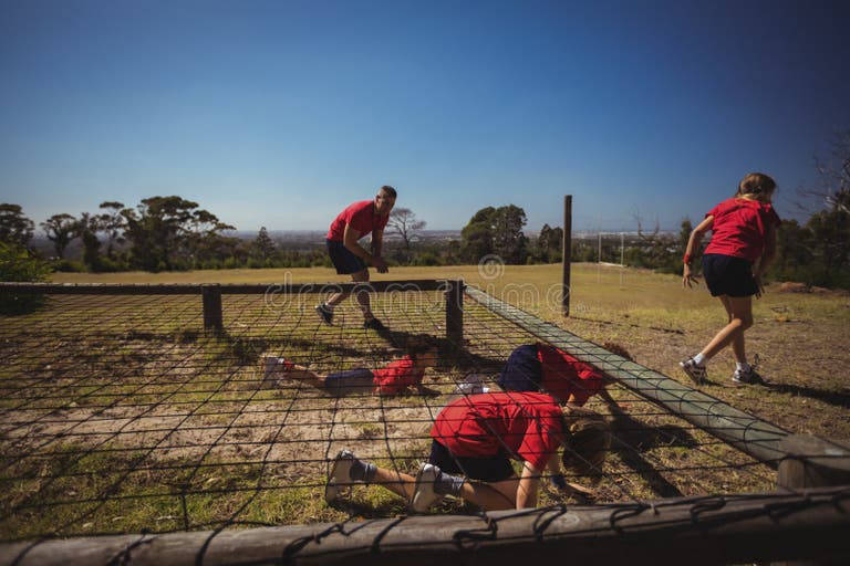 Kids Crawling Under the Net during Obstacle Course Training Stock Photo ...