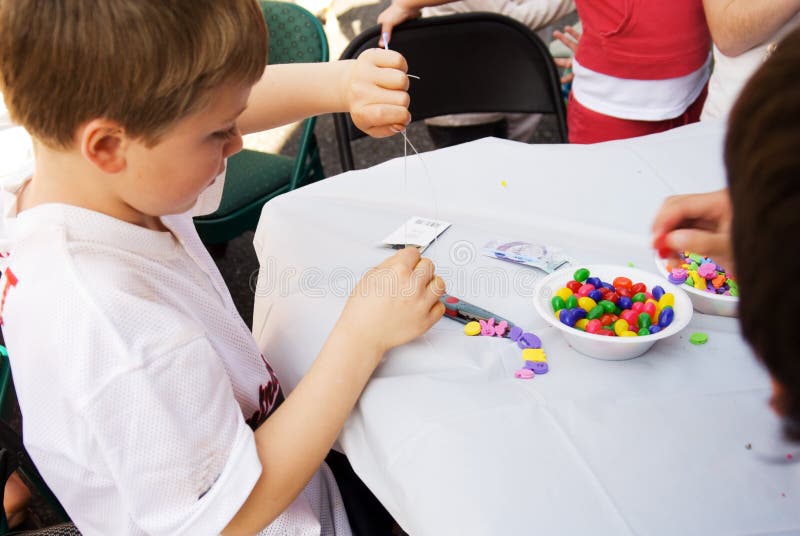 Kids doing crafts stock image. Image of colors, stringing - 4673511