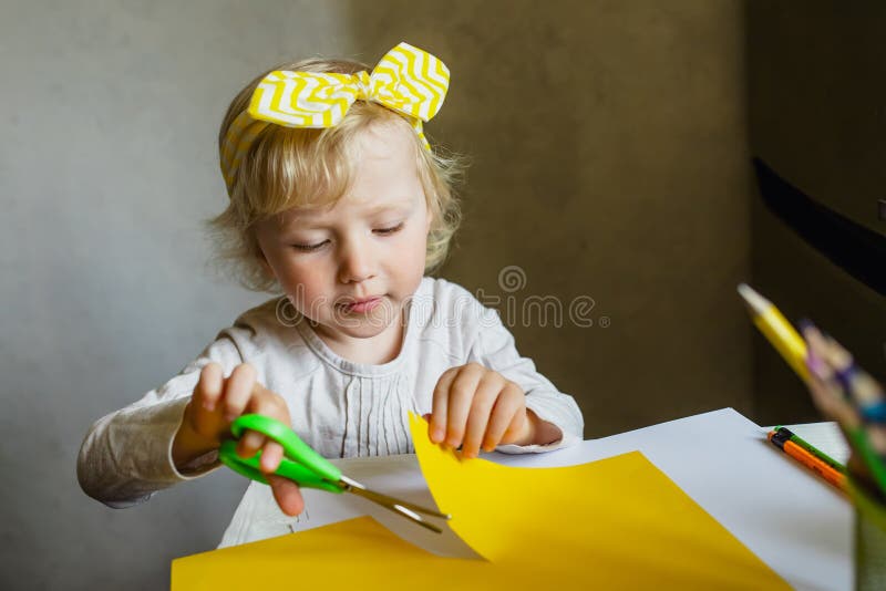 Little Girl Learns To Cut Out of Paper. Teaching Children Applications ...