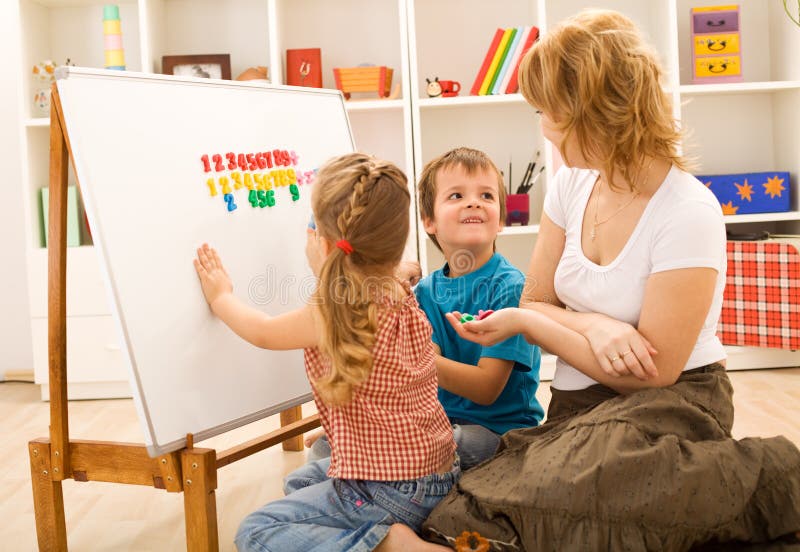 Kids Doing Math Exercises with Mom Stock Photo - Image of board ...