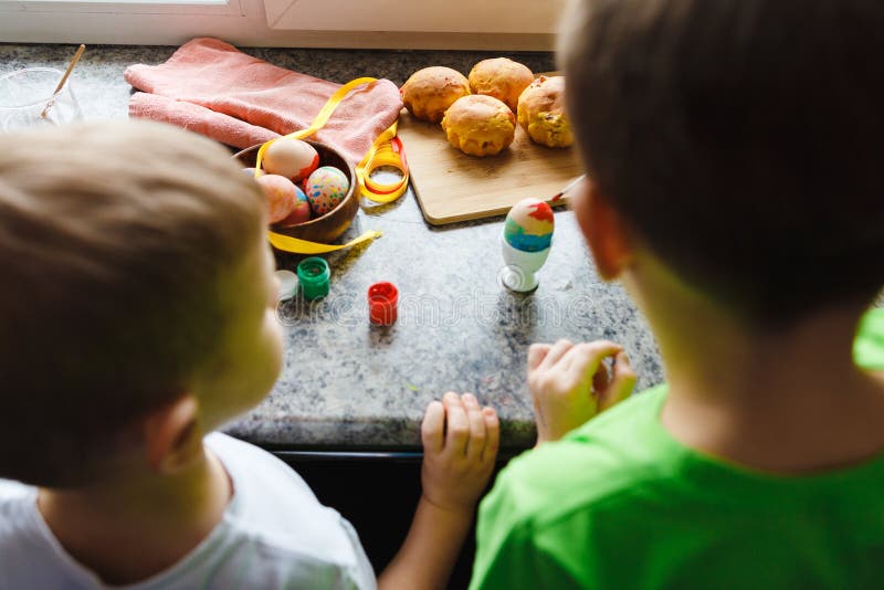 Kids Easter Preparation by Painting Easter Eggs and Holiday Decorations ...