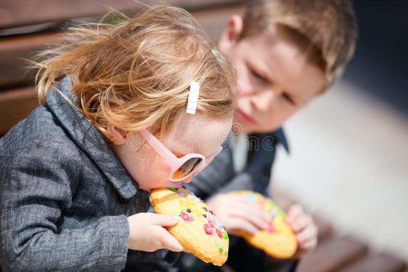Kids eating cookie stock image. Image of girl, adorable - 19493577