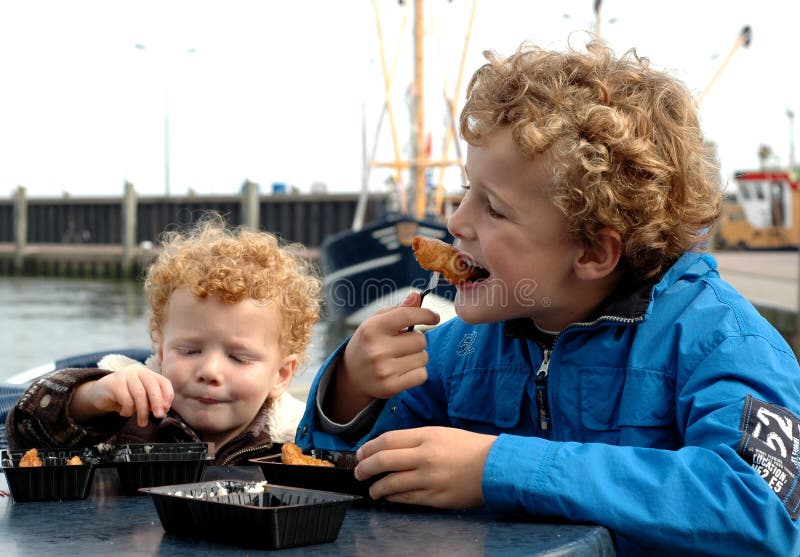 Kids eating fish stock image. Image of fishing, sibling - 6427731