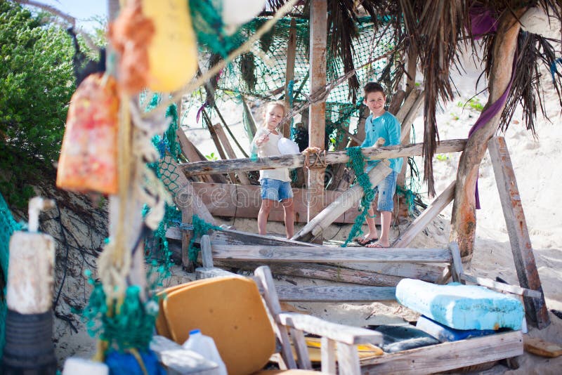Kids exploring beach hut stock photo. Image of playful - 37128118