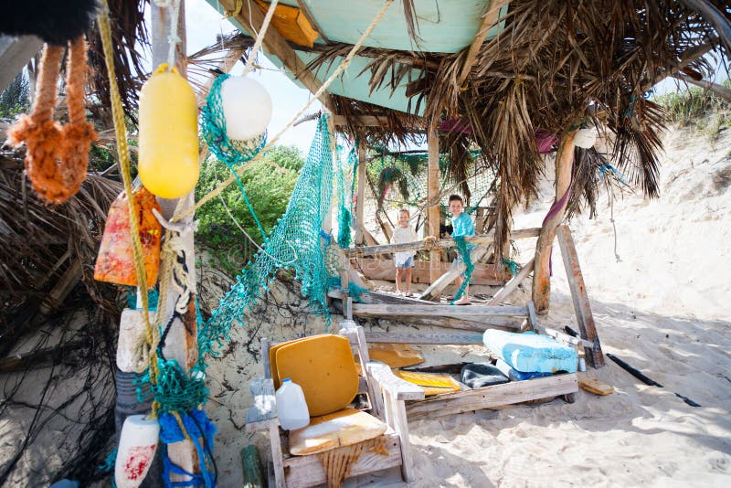 Kids exploring beach hut stock photo. Image of playful - 37128118