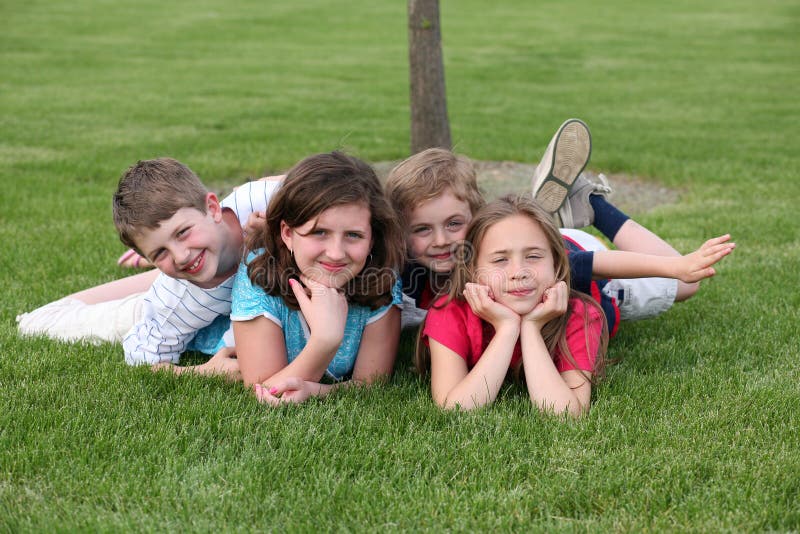Kids in the Grass stock photo. Image of caucasian, grass - 2415168