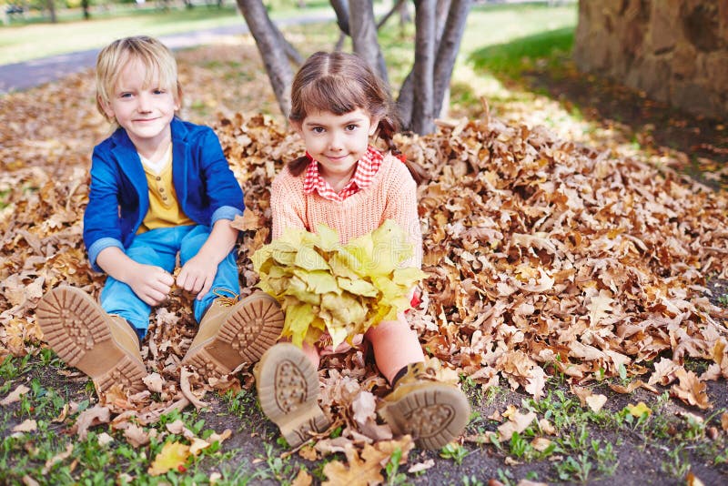 Kids on ground stock photo. Image of foliage, leaves - 77968602