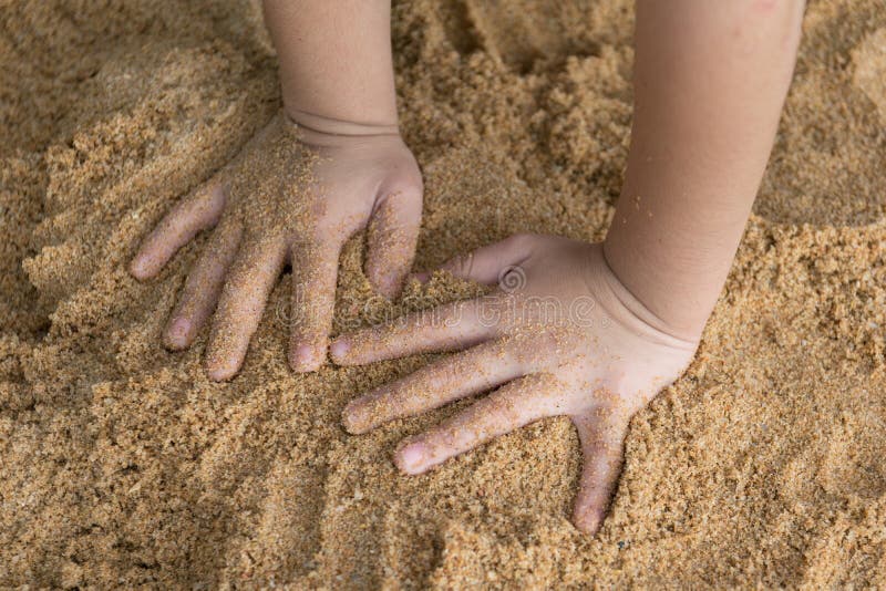 Kids hand on sand stock photo. Image of childhood, together - 65132264