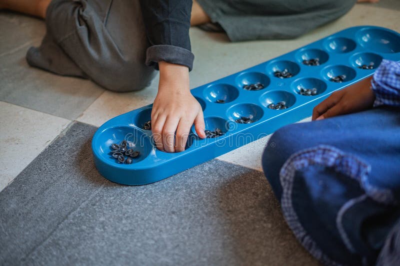 Kids Hand Taking Seeds from Board Playing Classic Games Stock Photo ...