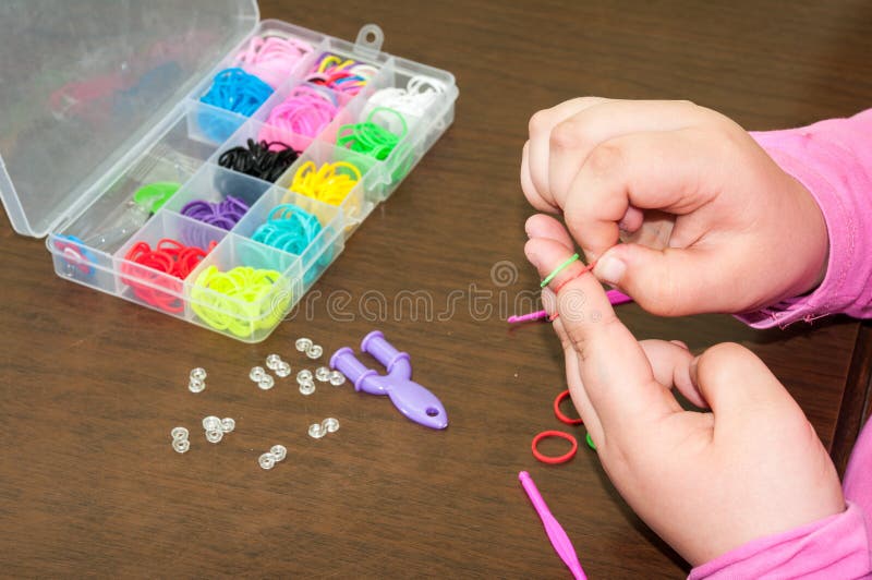 Kids Hands Creating Bracelet with Rubber Bands and Box in the Ba Stock ...