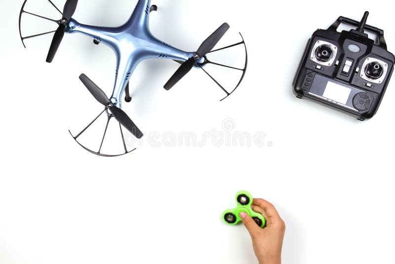 Kids Hands Playing with Fidget Spinner Toy. Drone and Remote Controller ...