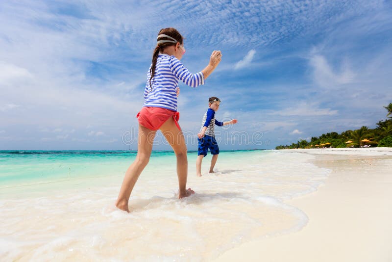Kids having fun at beach stock image. Image of jumping - 53967413