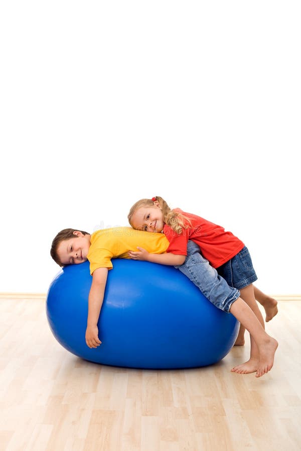 Kids Having Fun Relaxing on a Large Rubber Ball Stock Image - Image of ...