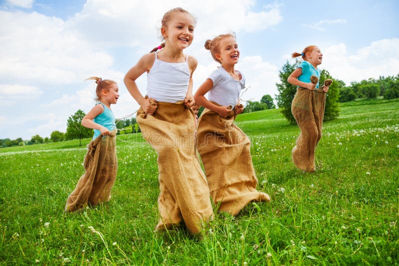 Kids Having Fun with Sacks on a Meadow Stock Photo - Image of flower ...
