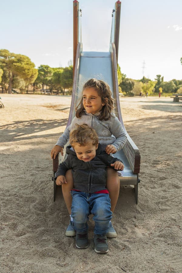 Kids Having Fun on Slide at the Playground Stock Photo - Image of ...