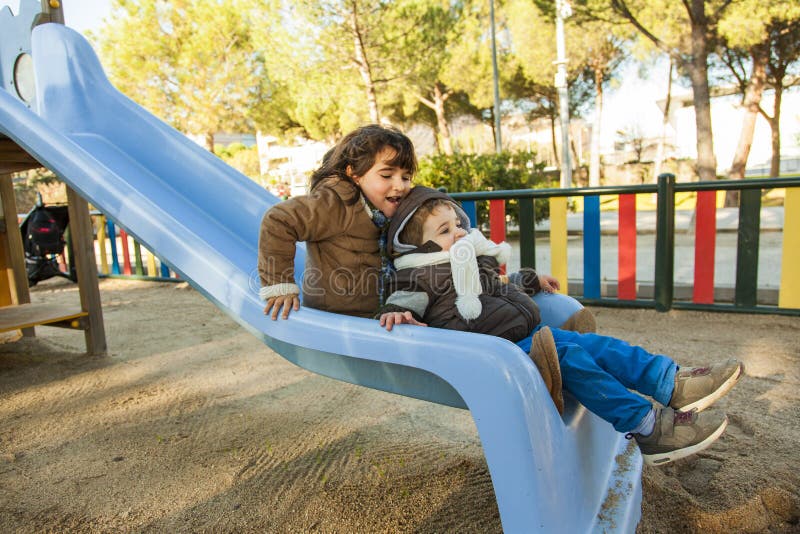Kids Having Fun on Slide at the Playground Stock Photo - Image of ...
