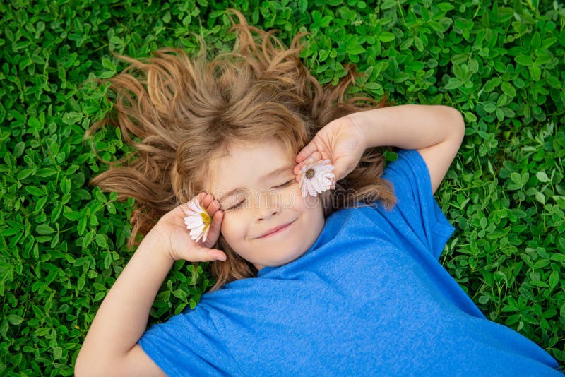 Kids Having Fun in Spring Park. Child Lying on Green Grass Stock Image ... Kids Having Fun in Spring Park. Child Lying on Green Grass Stock Image ...