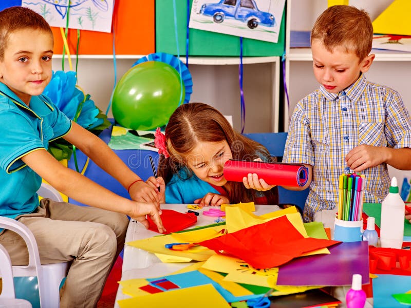 Kids Holding Colored Paper on Table in Stock Image - Image of chair ...