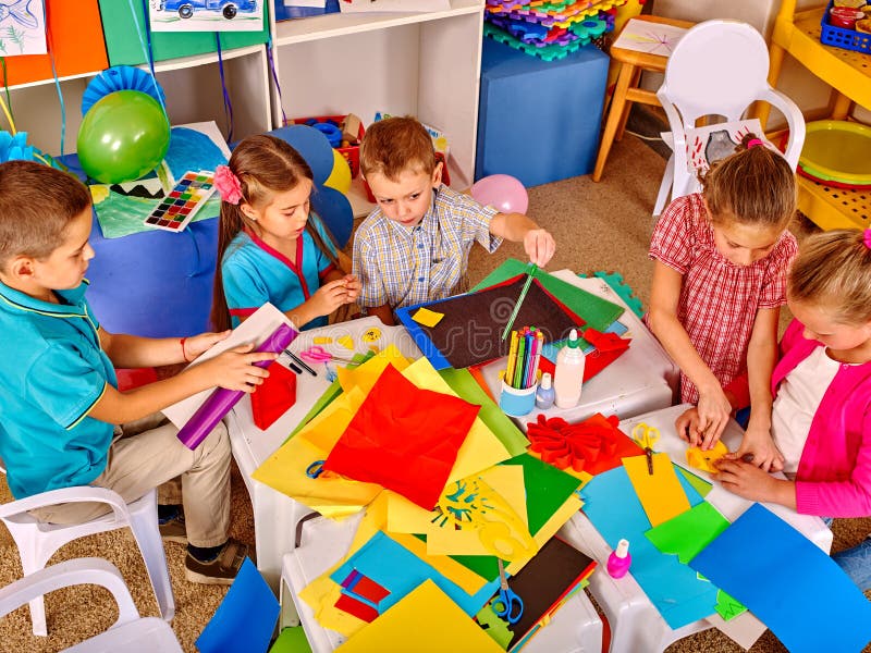 Kids Holding Colored Paper on Table in Kindergarten . Stock Image ...