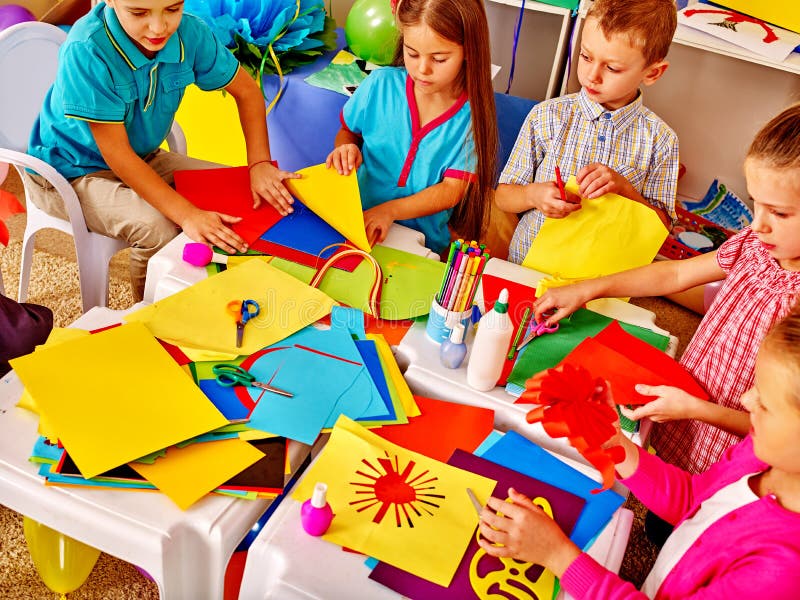 Kids Holding Colored Paper on Table in Stock Photo - Image of crayons ...
