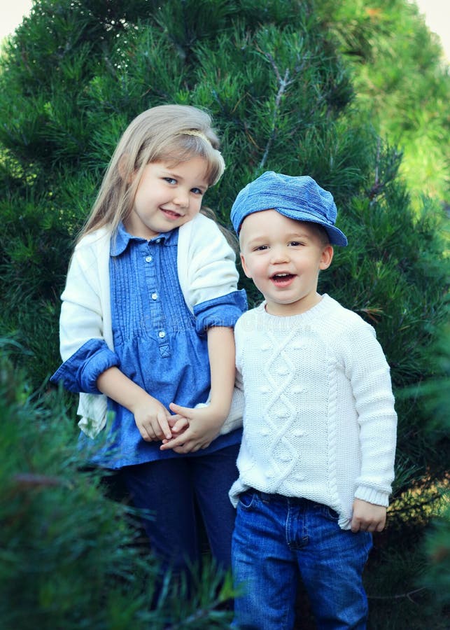 Kids Holding Hands in Pine Trees Stock Photo - Image of cool, cream ...