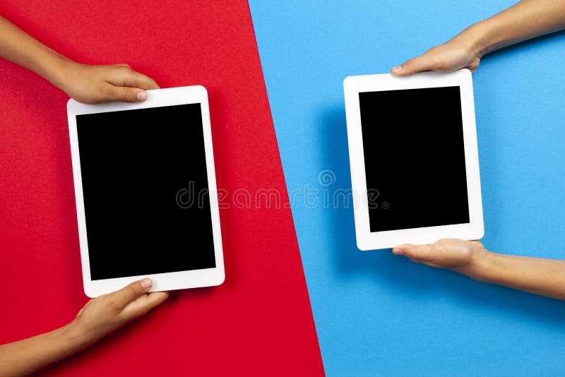 Kids Holding Tablet Computer Over Red and Light Blue Background Stock ...
