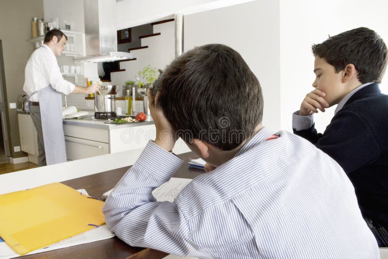 Kids with Homework and Dad Cooking Stock Image - Image of cooking, food ...