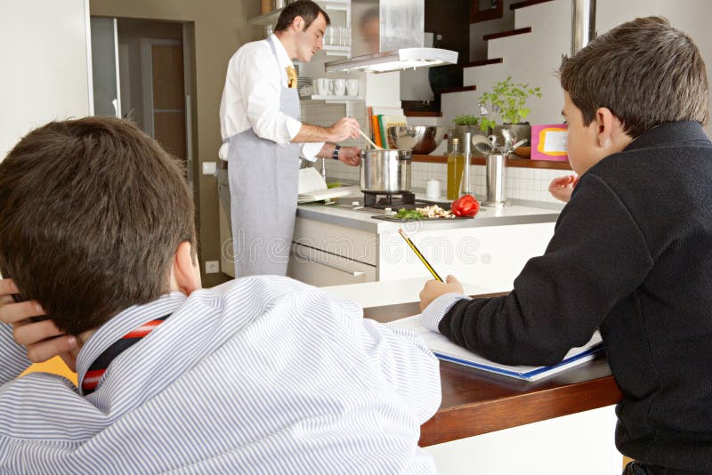 Kids with Homework and Dad Cooking Stock Photo - Image of feeding, blue ...