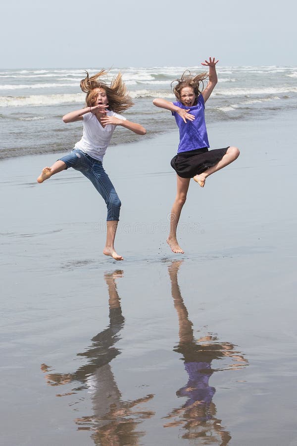 Kids jumping at the beach stock photo. Image of leaping - 42872324