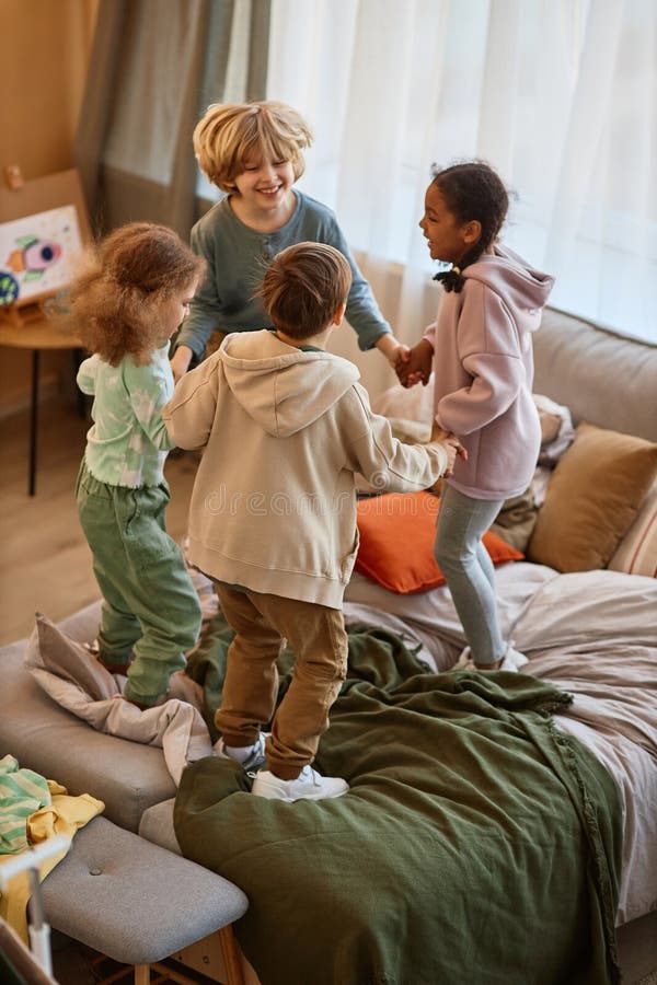 Kids Jumping on Bed Together and Holding Hands Stock Image - Image of ...
