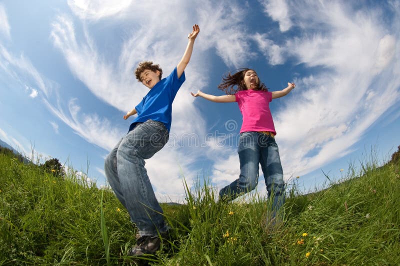 Kids jumping outdoor stock photo. Image of cloud, couple - 10781094
