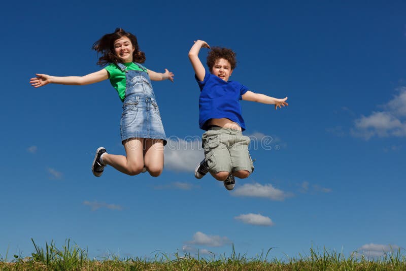 Kids jumping outdoor stock photo. Image of childhood - 53052170