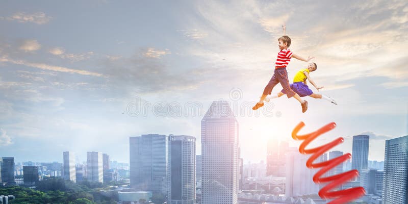 Kids jumping in the sky stock photo. Image of childhood - 184164028