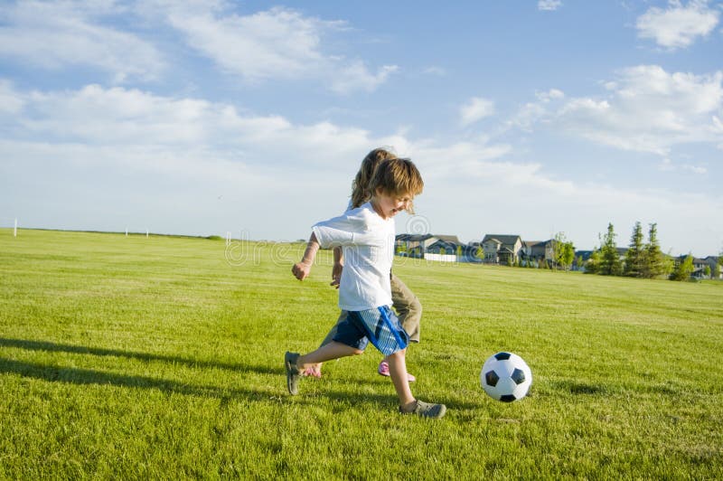 Kids kicking soccer ball stock image. Image of people - 29170377